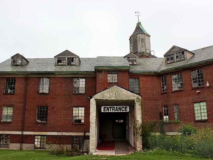 The entrance beckons with weathered concrete and a red carpet, like an invitation you're not sure you should accept.