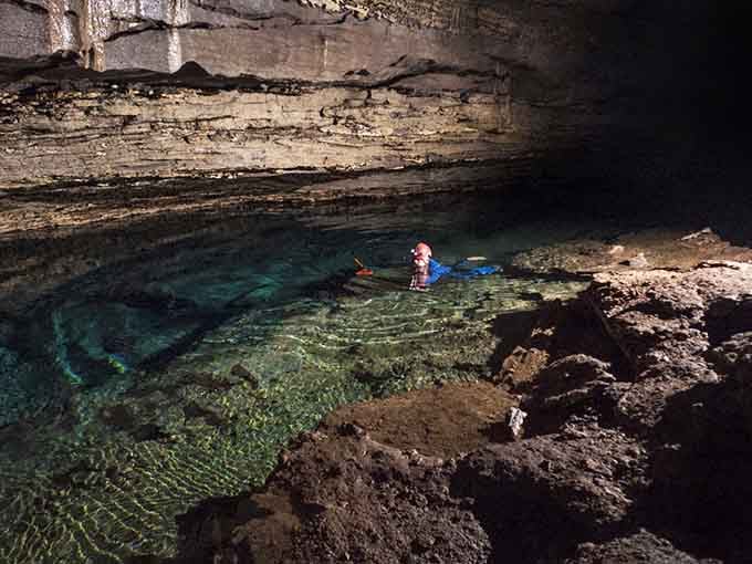 That emerald water glows like nature installed its own mood lighting thousands of years ago beneath the earth.