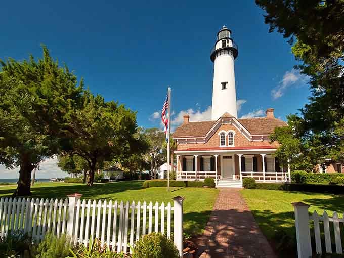 The white picket fence and brick pathway create a scene so pristine, Norman Rockwell would've grabbed his paintbrush.