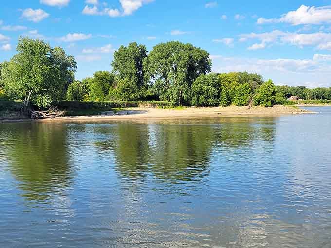 The Illinois River reflects clouds and trees like a mirror, proving that some of the best views cost absolutely nothing.