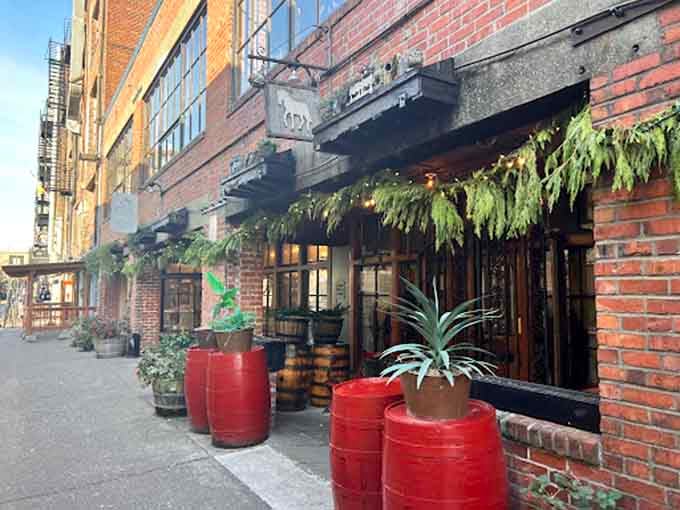 Brick walls, twinkling lights, and potted plants create an alleyway oasis that feels like stumbling into old-world Italy.