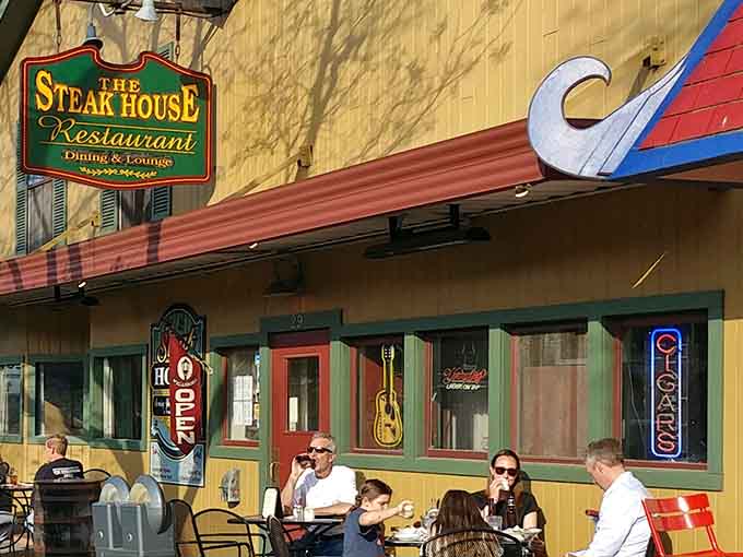 Outdoor seating with a guitar on the wall means good times ahead, like a Bonanza episode with better food.
