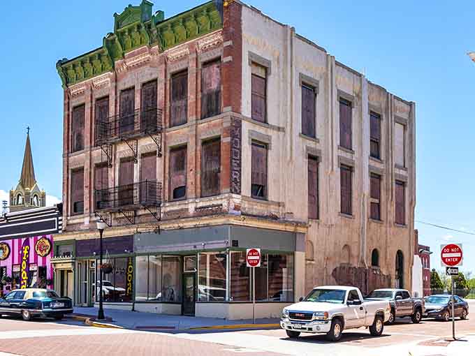 This weathered corner building stands proud like a character actor who's earned every wrinkle through decades of performance.
