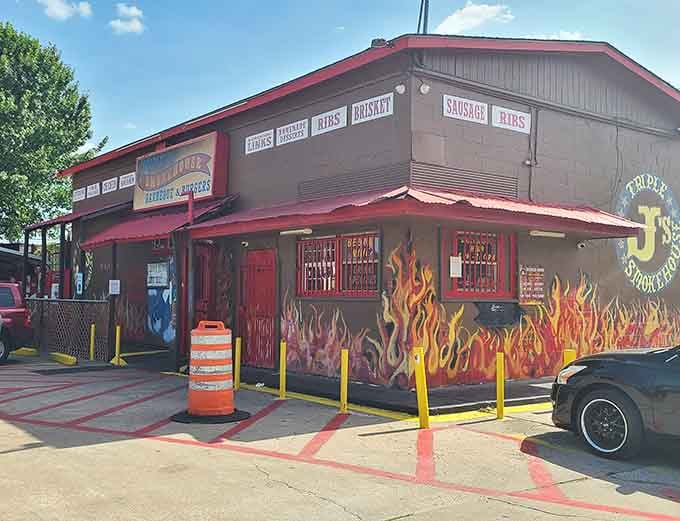Under blue skies, this Houston smokehouse stands ready with flame murals promising the smoky goodness waiting within.