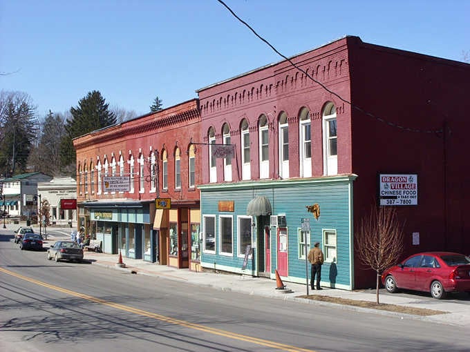 That turquoise storefront pops against the red brick like a mint on a chocolate cake – delightful!