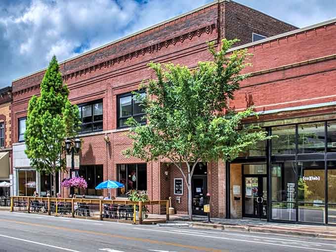 Outdoor dining under blue skies and leafy trees&mdash;this is where community gathers over coffee and conversation.