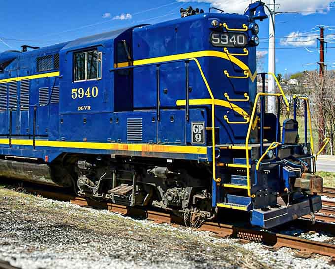 That brilliant blue paint job gleams under sunny skies, proving vintage locomotives can still turn heads like classic Cadillacs.