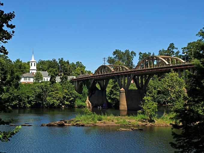 The white church steeple peeking through the trees makes this riverside view absolutely timeless and serene.