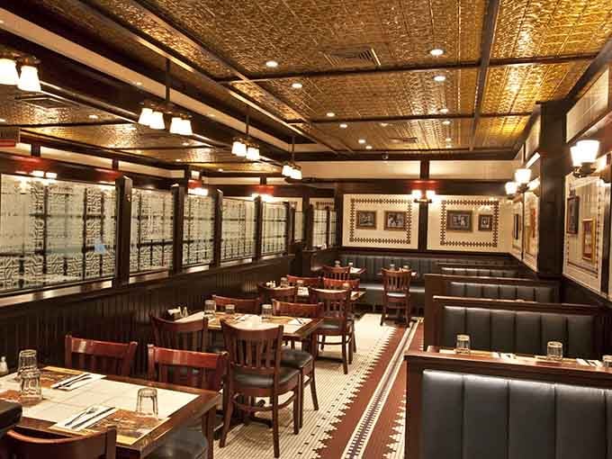 Classic deli elegance meets comfort: pressed tin ceilings, green booths, and the promise of legendary sandwiches.