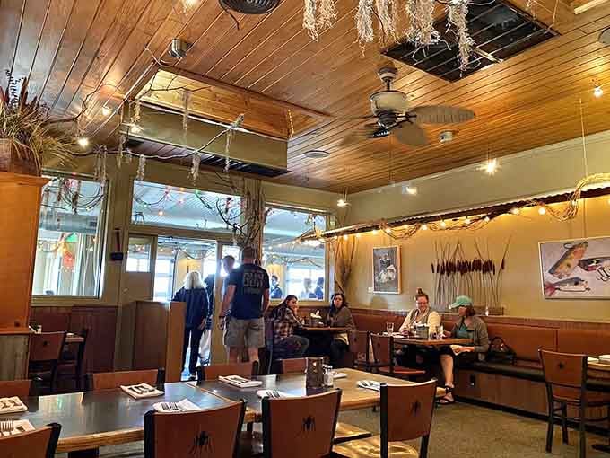 Dried grasses hanging overhead transform this dining room into an artistic coastal sanctuary worth exploring.