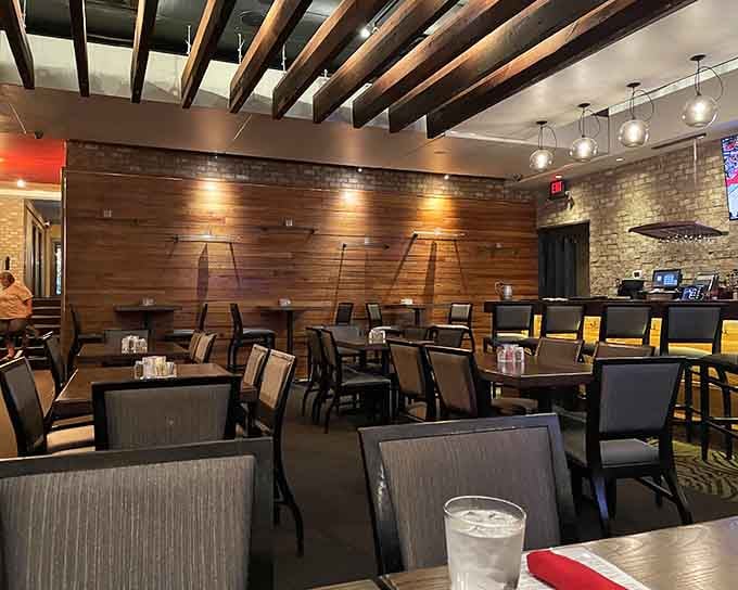 Exposed beams, warm lighting, and brick walls create an atmosphere that whispers "stay awhile" in every language.