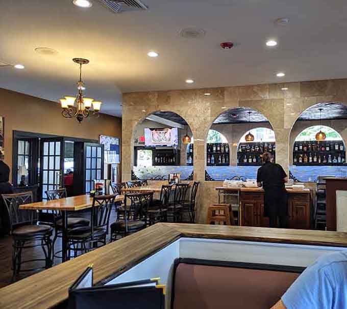 Warm lighting and cozy booths create the perfect setting for meals that require strategic planning and possibly a nap afterward.