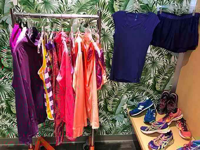 Tropical wallpaper meets athletic wear in a display that somehow makes perfect sense in thrift store logic.