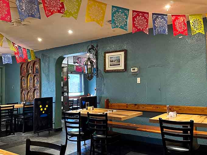 Turquoise walls and papel picado banners create a fiesta atmosphere that feels like a warm hug from your favorite aunt.