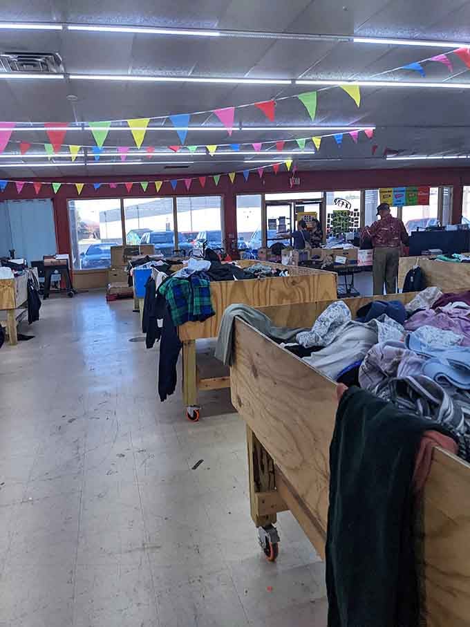 Wooden bins on wheels transform bargain hunting into an organized adventure through mountains of discounted merchandise.