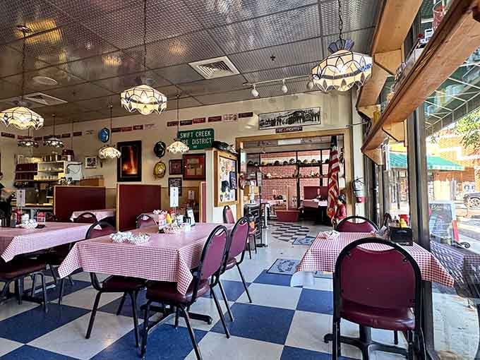 Checkered floors and gingham tablecloths create a diner vibe that feels like coming home to comfort.
