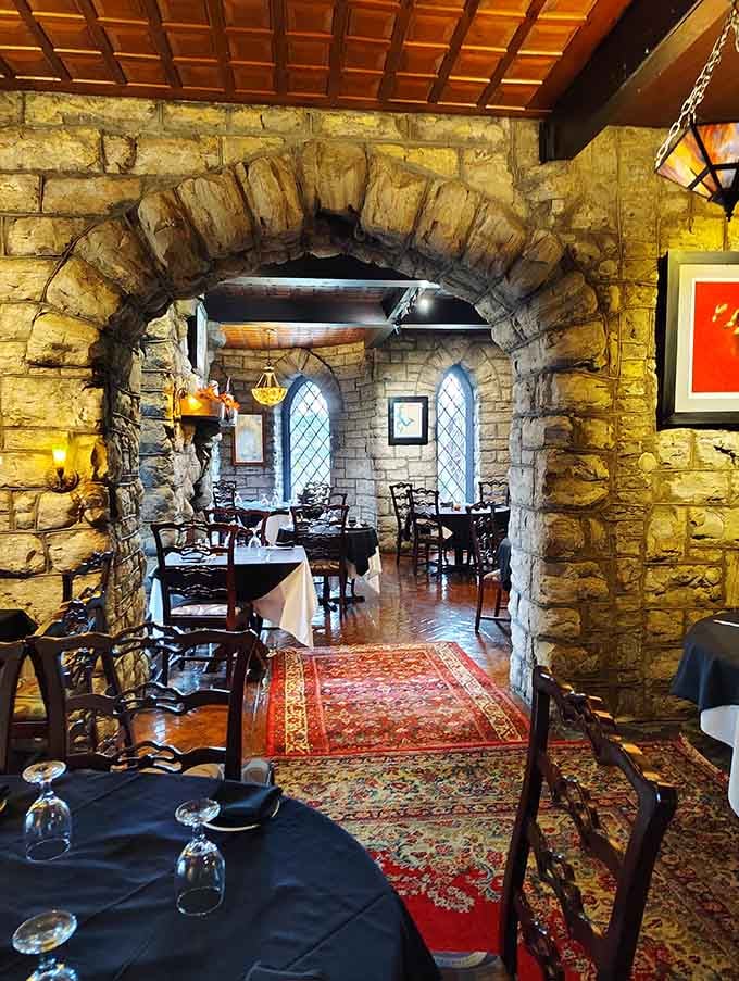 Massive stone archways frame intimate dining spaces where medieval charm meets modern comfort perfectly.