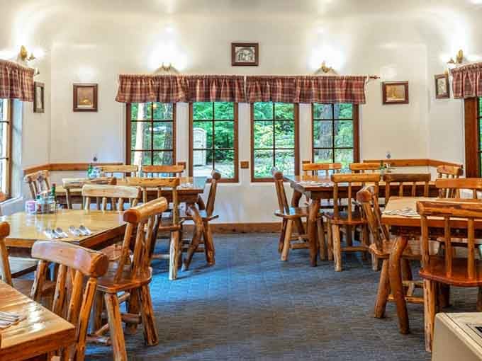 Checkered curtains, solid wood furniture, and forest views create the coziest mountain dining room you'll find anywhere.