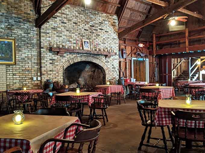 Step inside and discover rustic elegance where exposed beams meet that magnificent brick fireplace creating pure dining magic.