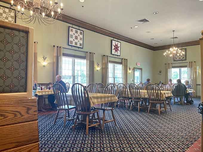 Spacious dining room with quilts on the walls, because nothing says "prepare to loosen your belt" like traditional decor.