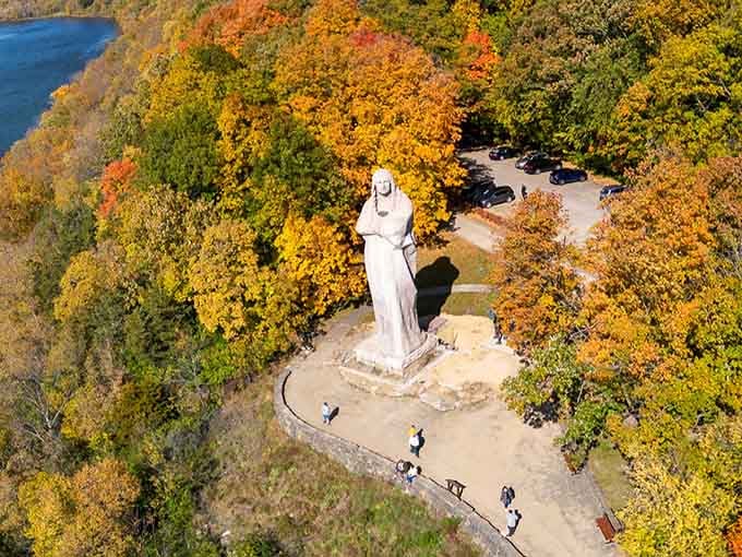 From above, the statue looks like nature's own chess piece, perfectly positioned among autumn's colorful canvas.