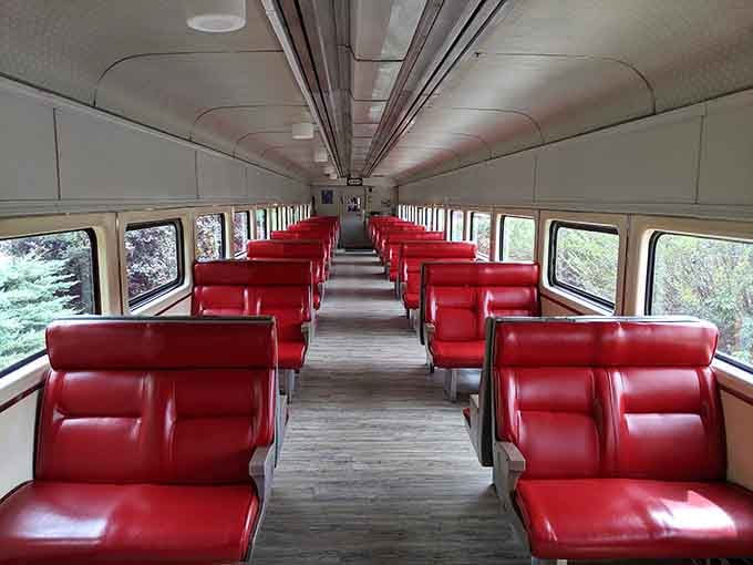 Those cherry-red seats inside the classic coach car are calling your name louder than your couch ever could.