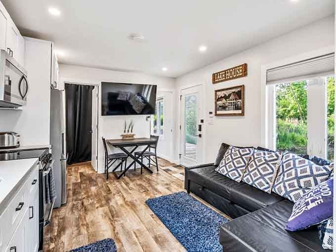 Clean lines, warm wood floors, and nautical touches create a space that's both cozy and surprisingly spacious.