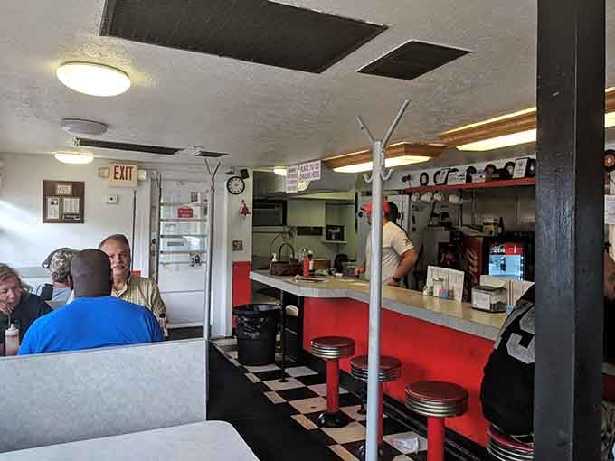 Red stools at a vintage counter where strangers become friends over burgers, just like diners were meant to be.