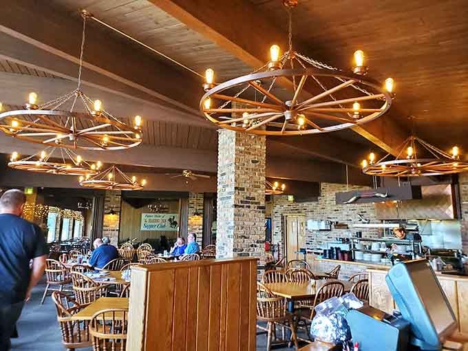 Wagon wheel chandeliers and warm wood tones create the kind of atmosphere where time slows down deliciously.