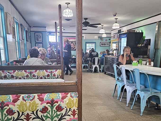 Colorful booth patterns and vintage lighting create that rare diner atmosphere where strangers become breakfast buddies.