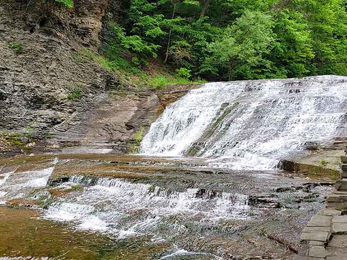 The main waterfall spreads across ancient rock like a bridal veil, creating that postcard-perfect moment you've been chasing.