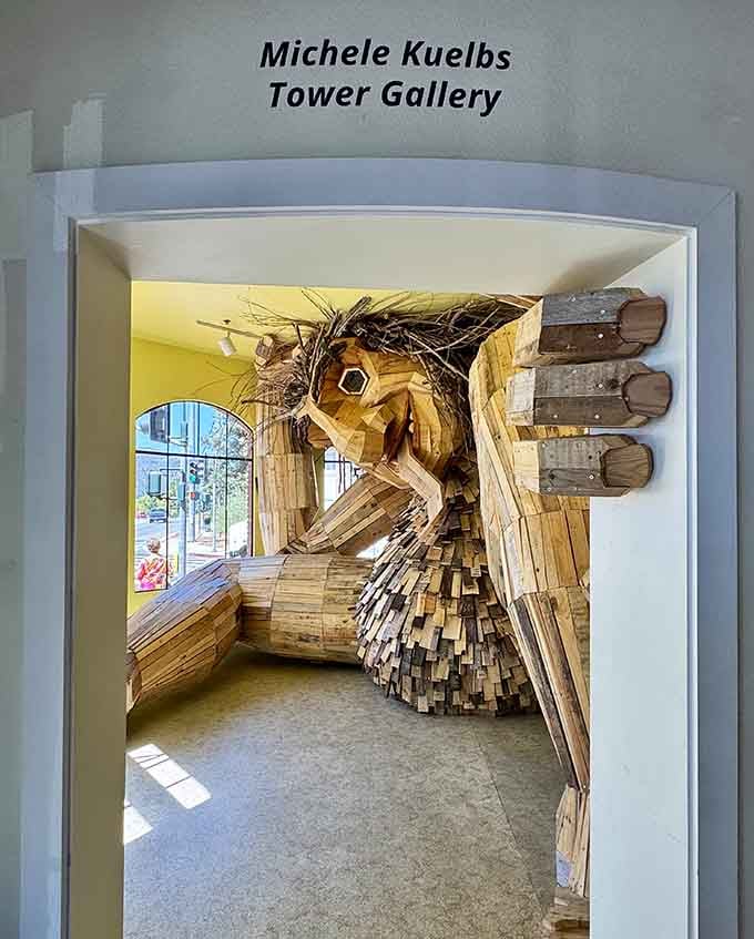 Through the Michele Kuelbs Tower Gallery entrance, the troll awaits with wild hair and welcoming presence.