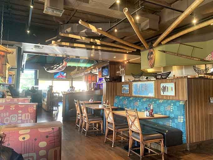 Those suspended canoes overhead aren't just decoration, they're your first clue that someone here takes the Hawaiian theme seriously.