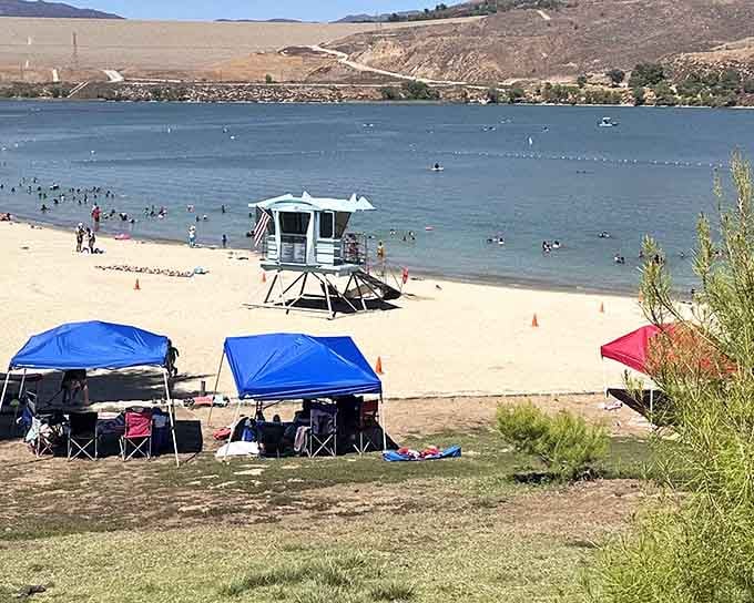 Those blue canopies mean serious relaxation is happening, complete with lifeguard tower standing watch like a beach movie set.