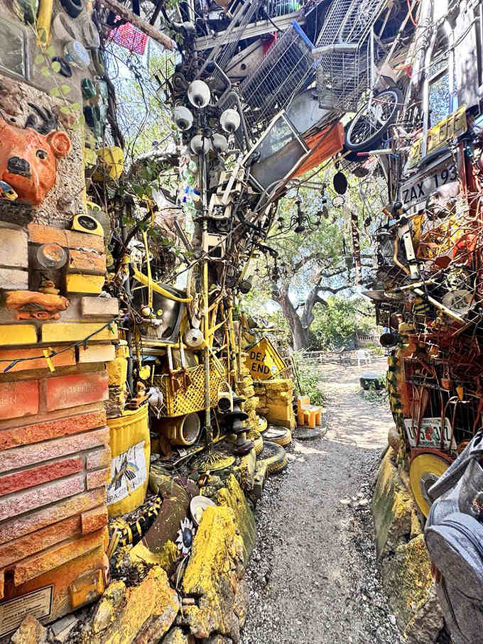 Step through the looking glass where discarded treasures become towering art, one hubcap at a time.