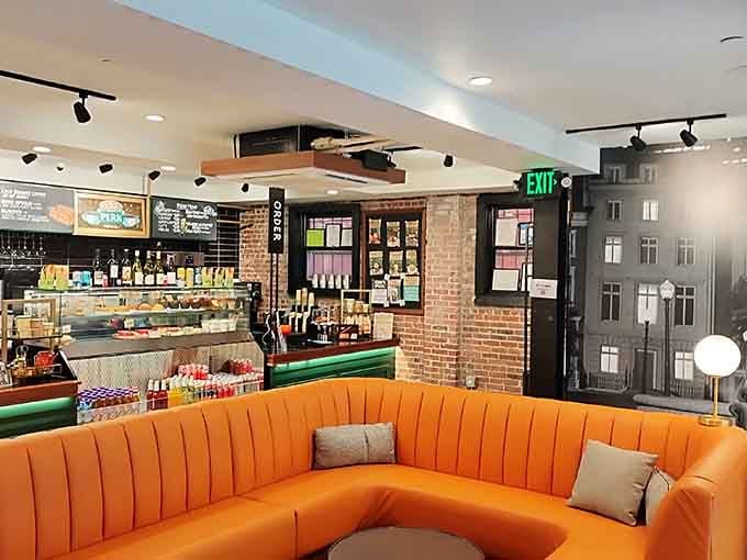 The orange couch sits there like a celebrity, patiently waiting for its next photo op with adoring fans.