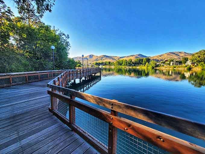 The wooden boardwalk stretches over water so blue it looks like someone's desktop screensaver come to life.