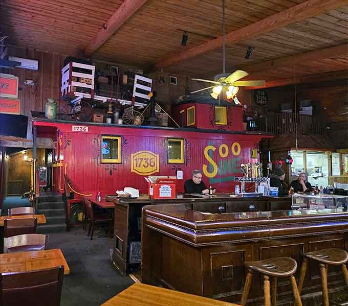 Yes, that's a full-sized caboose dominating the dining room, because why settle for ordinary when extraordinary is available?