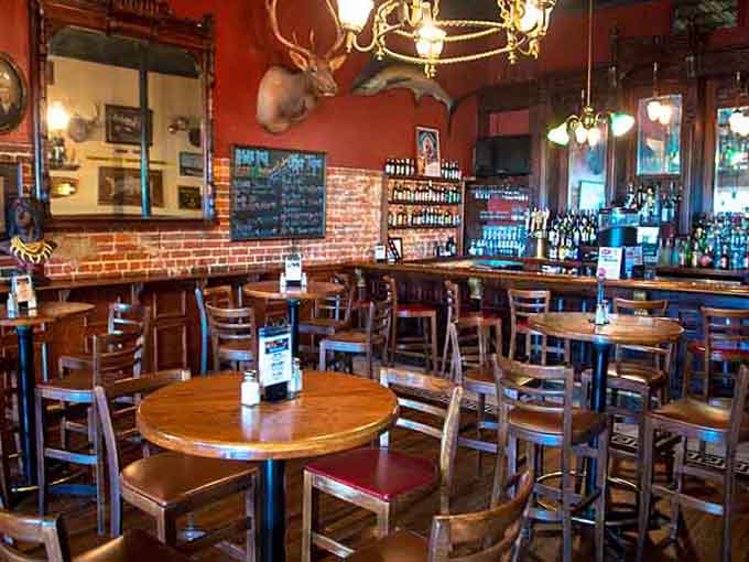 Exposed brick, warm wood, and brass fixtures create an atmosphere that feels earned, not manufactured by some corporate design team.