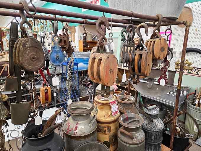 Wooden pulleys and vintage crocks create a display that's part hardware store, part time machine.