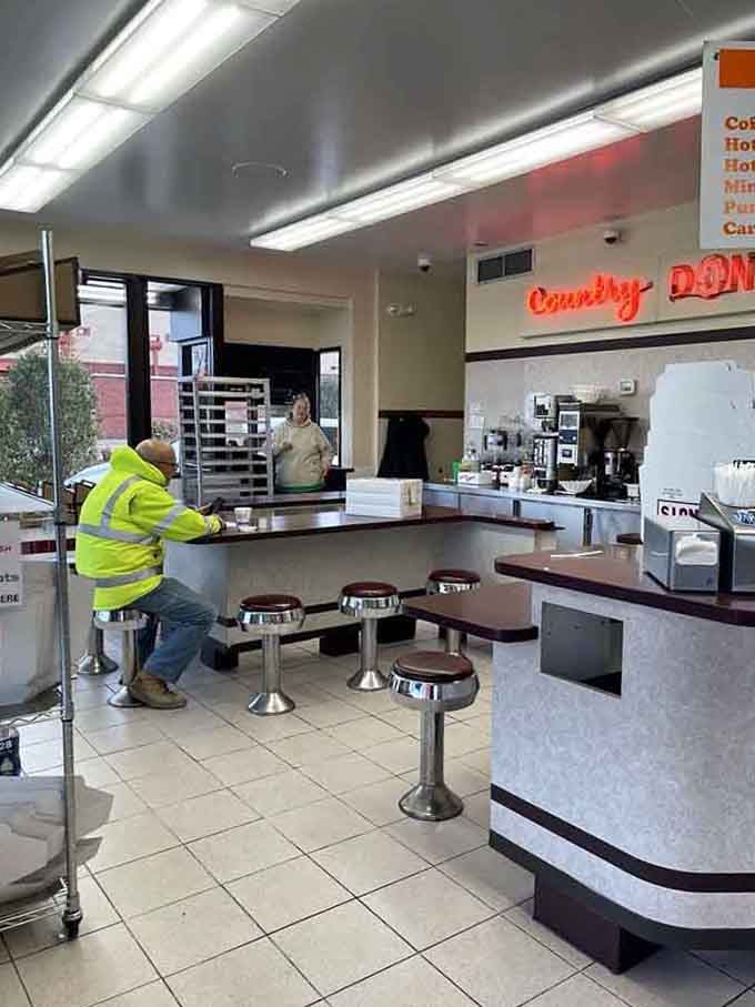 Chrome stools and clean counters create the perfect stage where donut dreams become delicious reality every single day.