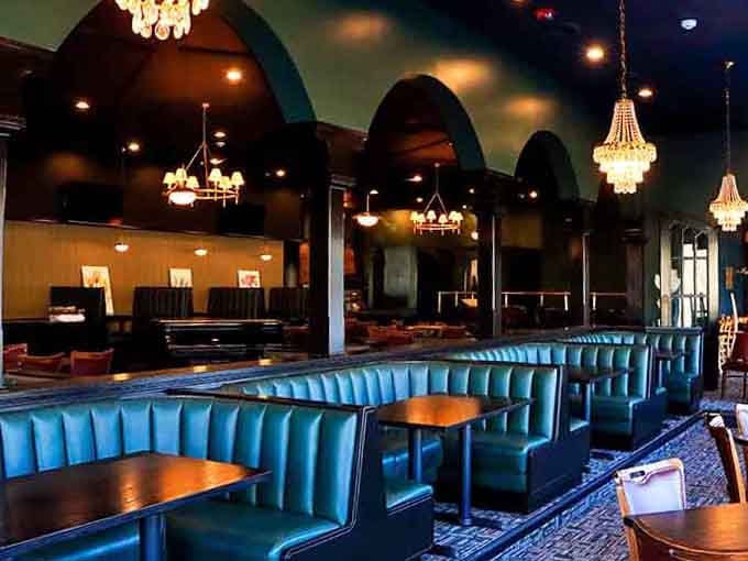 Those turquoise booths and sparkling chandeliers create an atmosphere that's pure classic steakhouse elegance without the stuffiness.