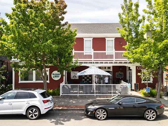 That charming red facade and welcoming porch whisper promises of homestyle cooking and genuine small-town hospitality inside.