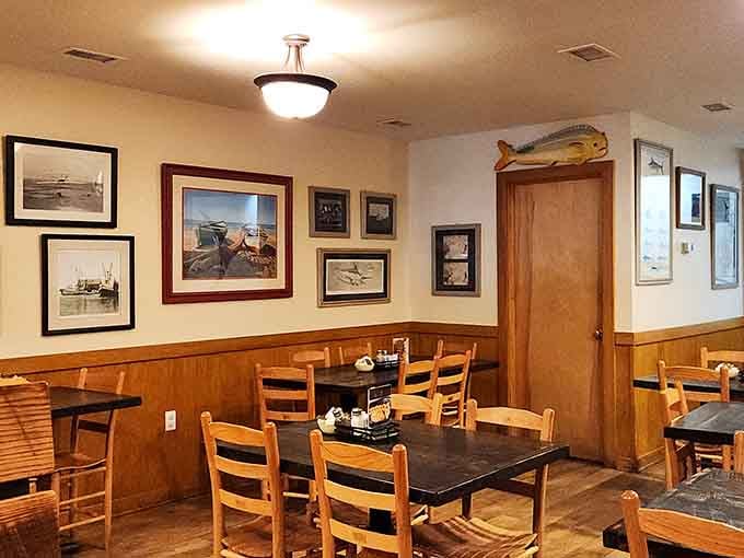 Wood paneling and maritime art create the kind of cozy atmosphere where good conversations happen over great seafood.