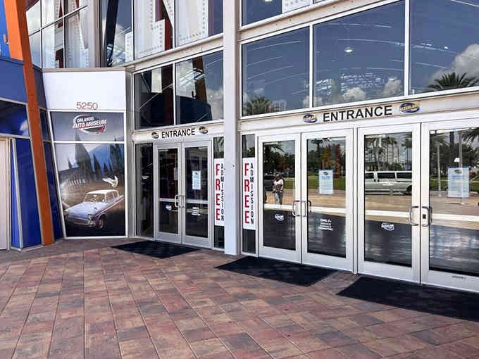 Clean glass doors and classic car imagery hint at the automotive treasures waiting just beyond this welcoming threshold.