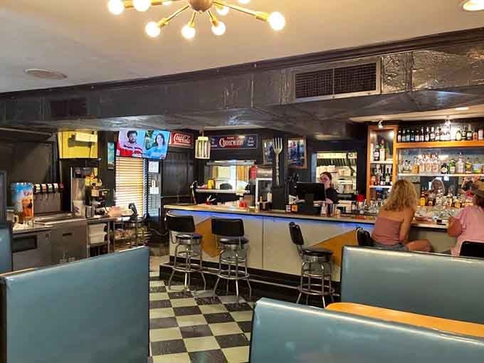 Step inside and those turquoise booths against checkered floors transport you straight to diner heaven, no time machine required.