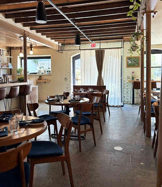 Exposed beams and blue cushions create a space so inviting, you'll want to move in permanently.