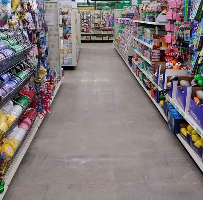 Wide aisles stretch endlessly, proving that dollar stores can feel spacious instead of cramped and claustrophobic.
