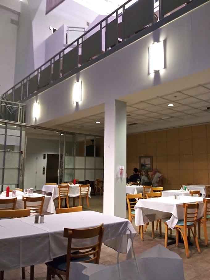 High ceilings and white tablecloths create an unexpectedly elegant atmosphere for a neighborhood cafe lunch destination.