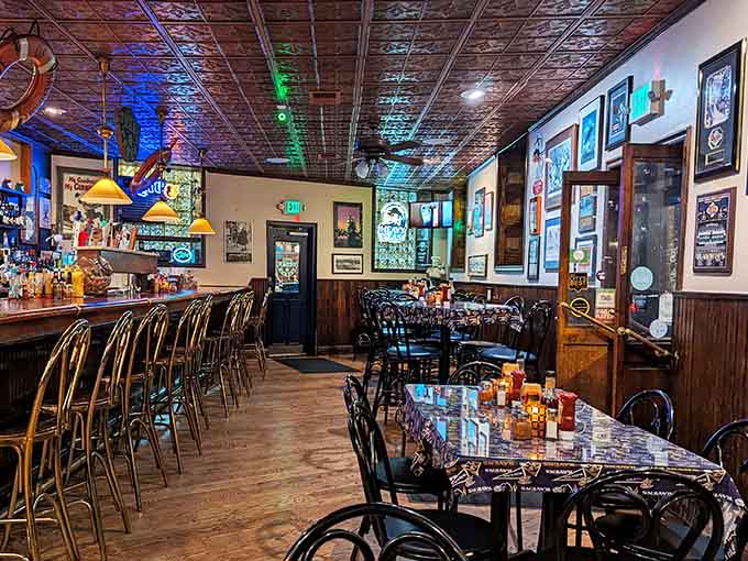 The tin ceiling and warm lighting create the kind of atmosphere where time slows down and conversations actually happen.